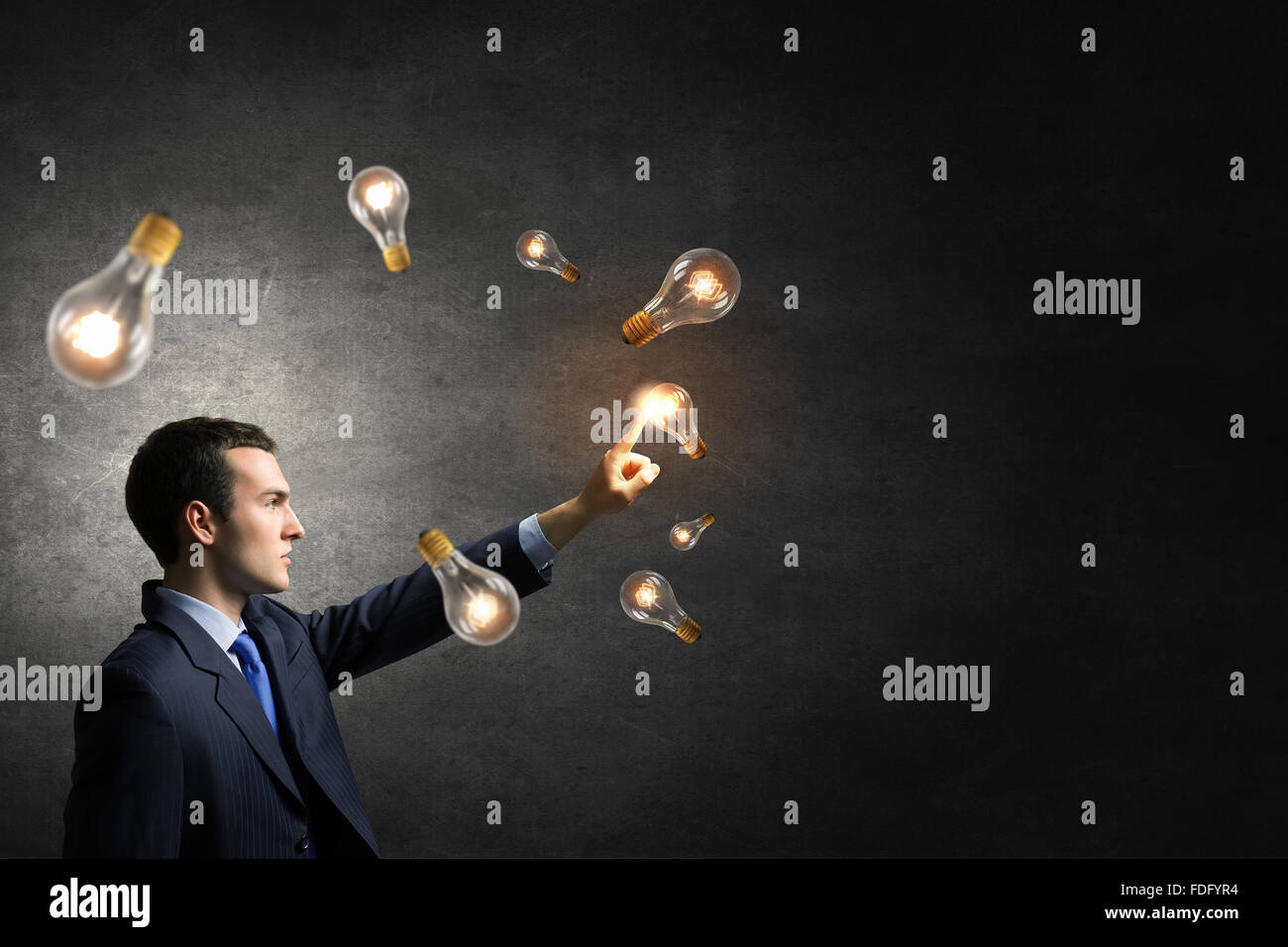 Businessman reaching hand to touch glass light bulb Stock Photo - Alamy