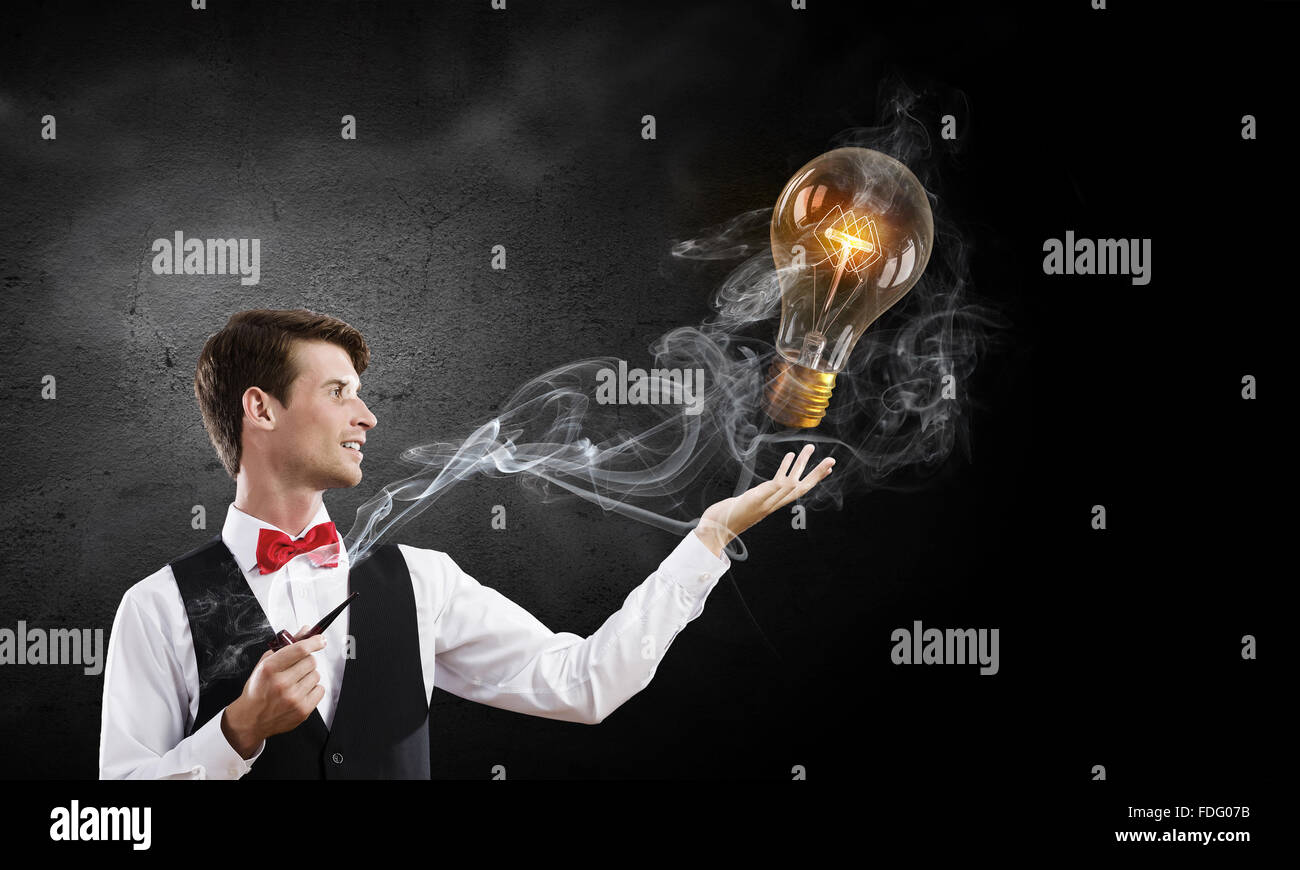 Handsome young businessman thinking over ideas and smoking pipe Stock ...