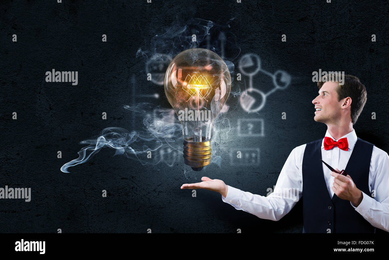 Handsome young businessman thinking over ideas and smoking pipe Stock ...