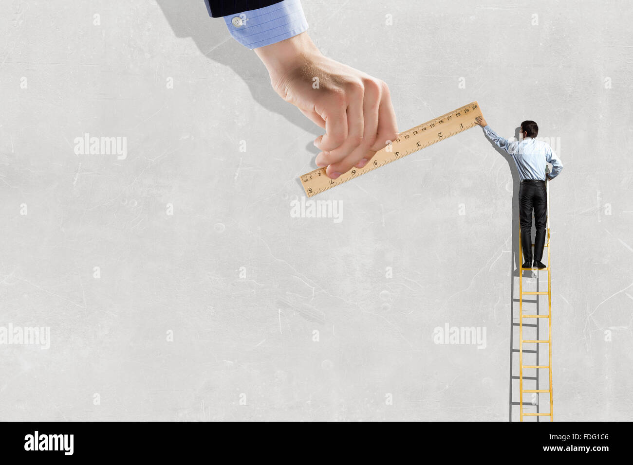 Businessman standing on ladder and hand with wooden ruler Stock Photo ...