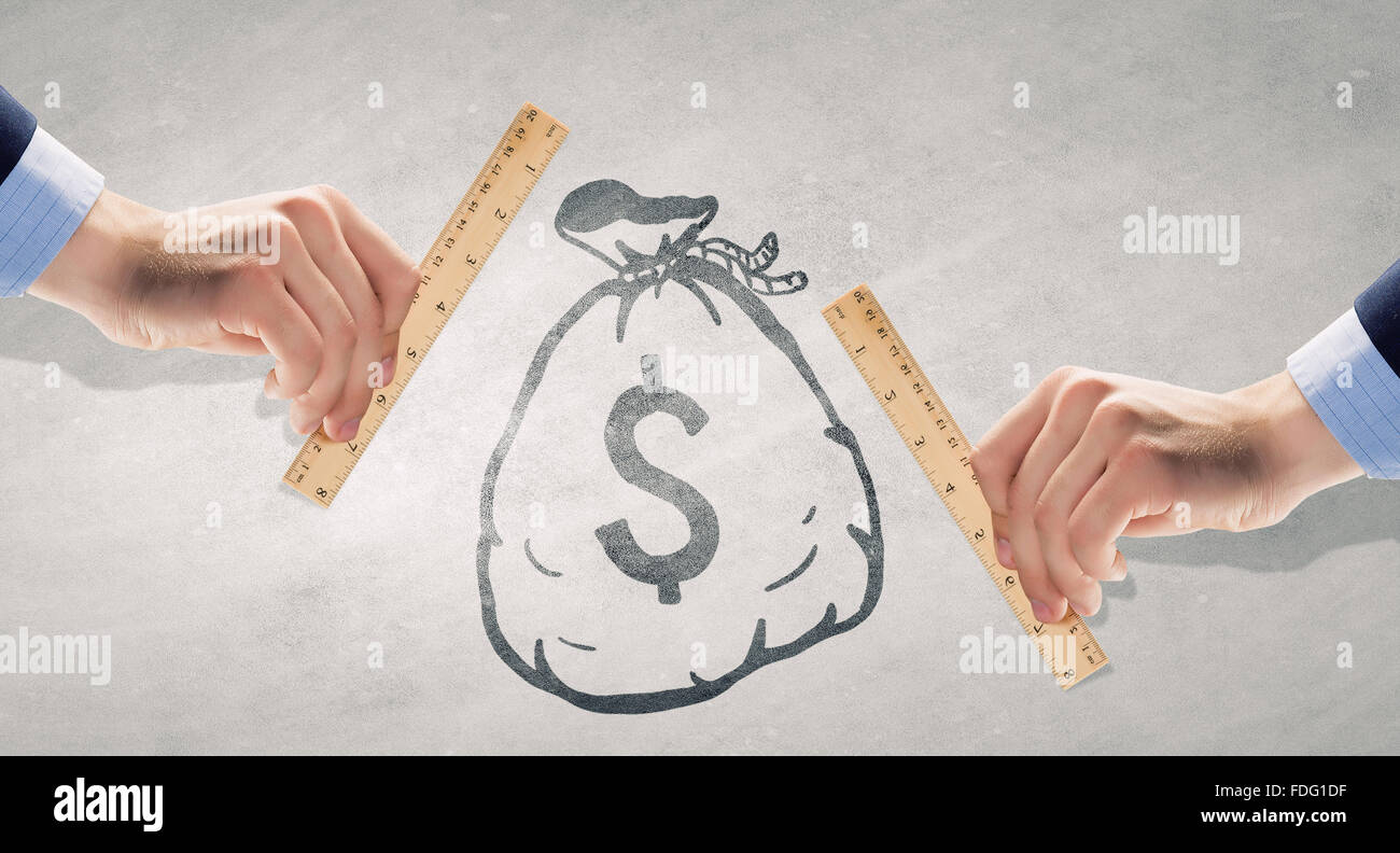 Close up of human hand measuring money bag with ruler Stock Photo - Alamy