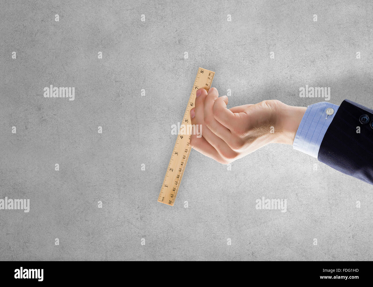 Close up of hand measuring with wooden ruler Stock Photo - Alamy