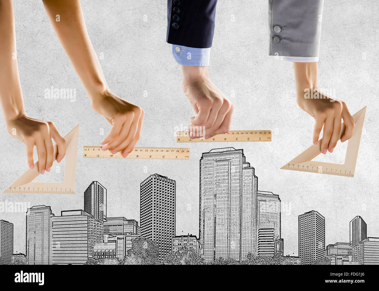 Close up of male hand measuring with ruler model of city Stock Photo ...