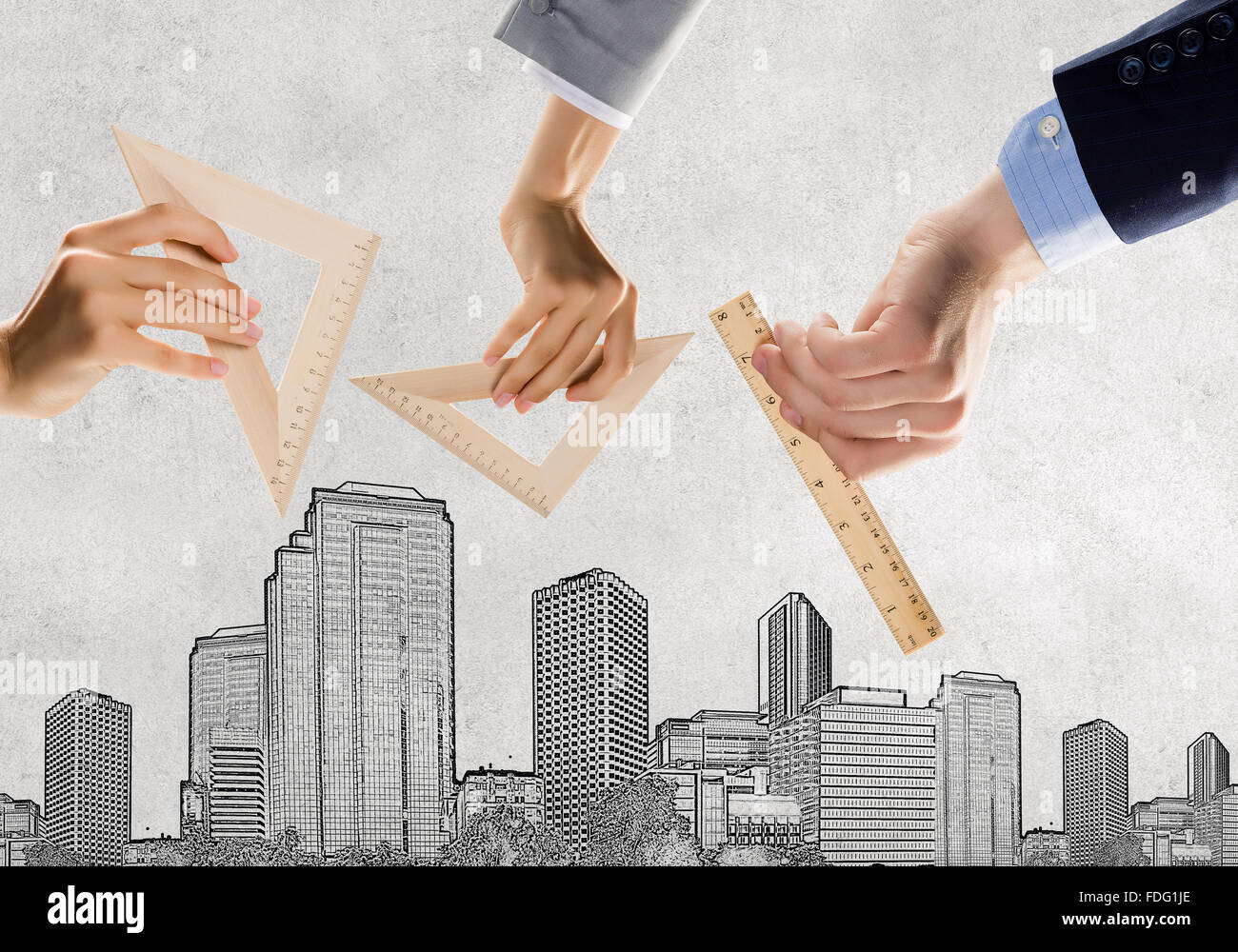 Close up of male hand measuring with ruler model of city Stock Photo ...