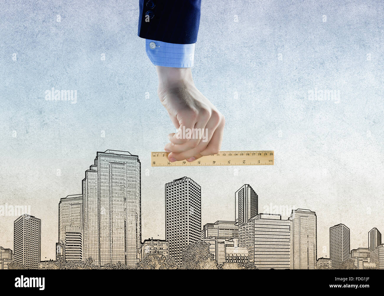 Close up of male hand measuring with ruler model of city Stock Photo ...