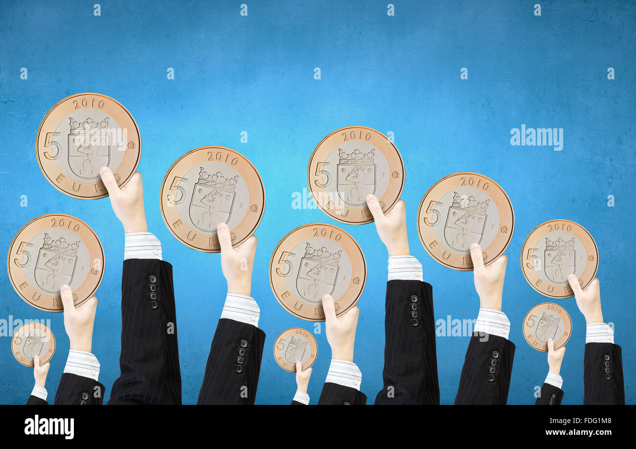 Crowd of people holding five euro coin Stock Photo - Alamy