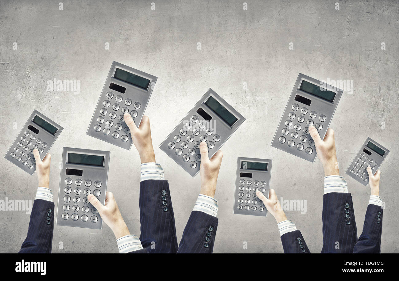 Many hands of business people holding calculators Stock Photo - Alamy