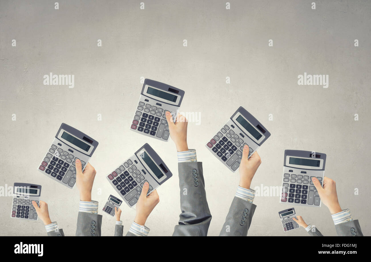 Many hands of business people holding calculators Stock Photo - Alamy