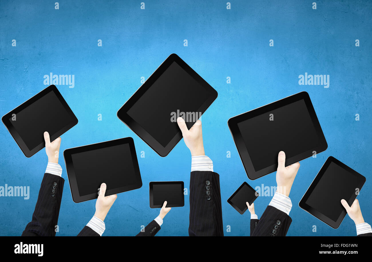 Team of business people holding tablets in hands Stock Photo - Alamy