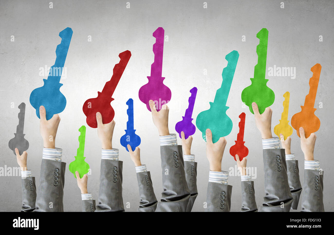 Many hands of business people holding keys Stock Photo - Alamy