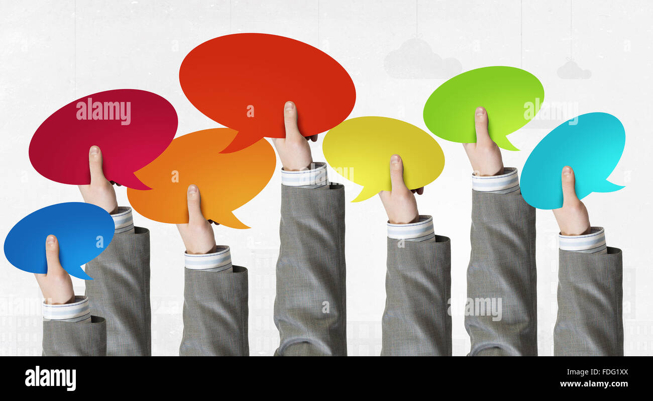 Group of business people holding chat cards in raised hands Stock Photo ...