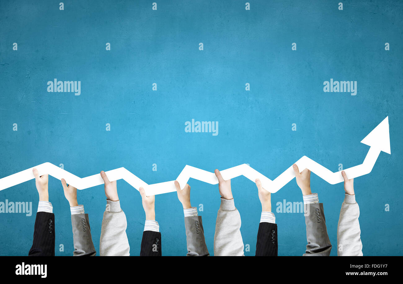 Group of business people holding growing graph in raised hands Stock ...