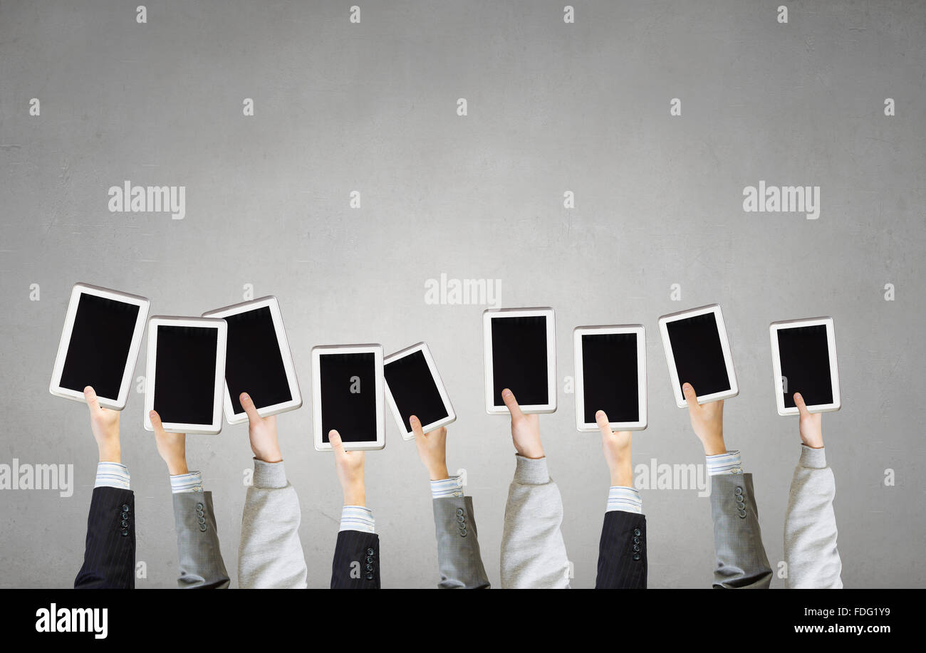 Team of business people holding tablets in hands Stock Photo - Alamy
