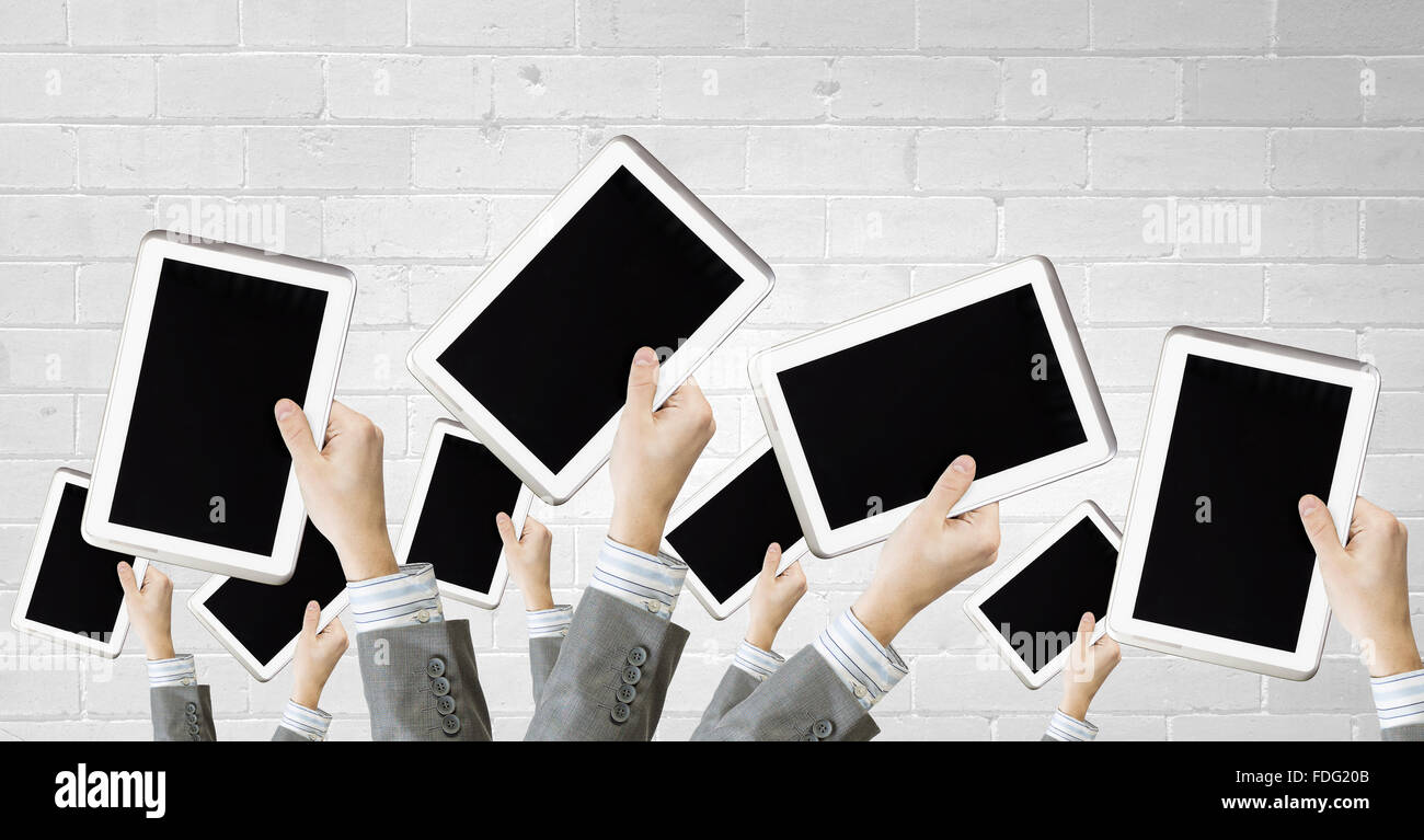Team of business people holding tablets in hands Stock Photo - Alamy