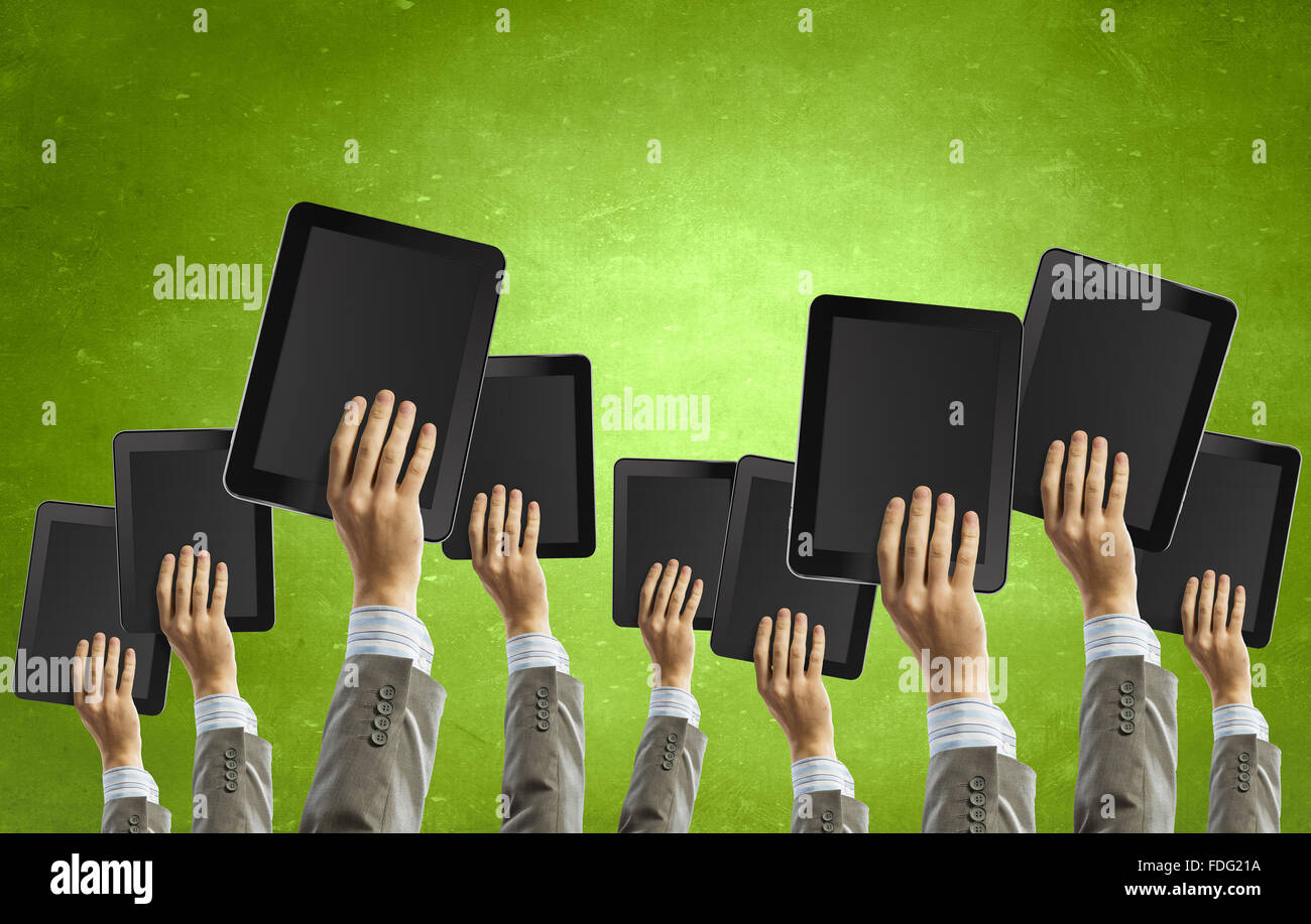 Team of business people holding tablets in hands Stock Photo - Alamy