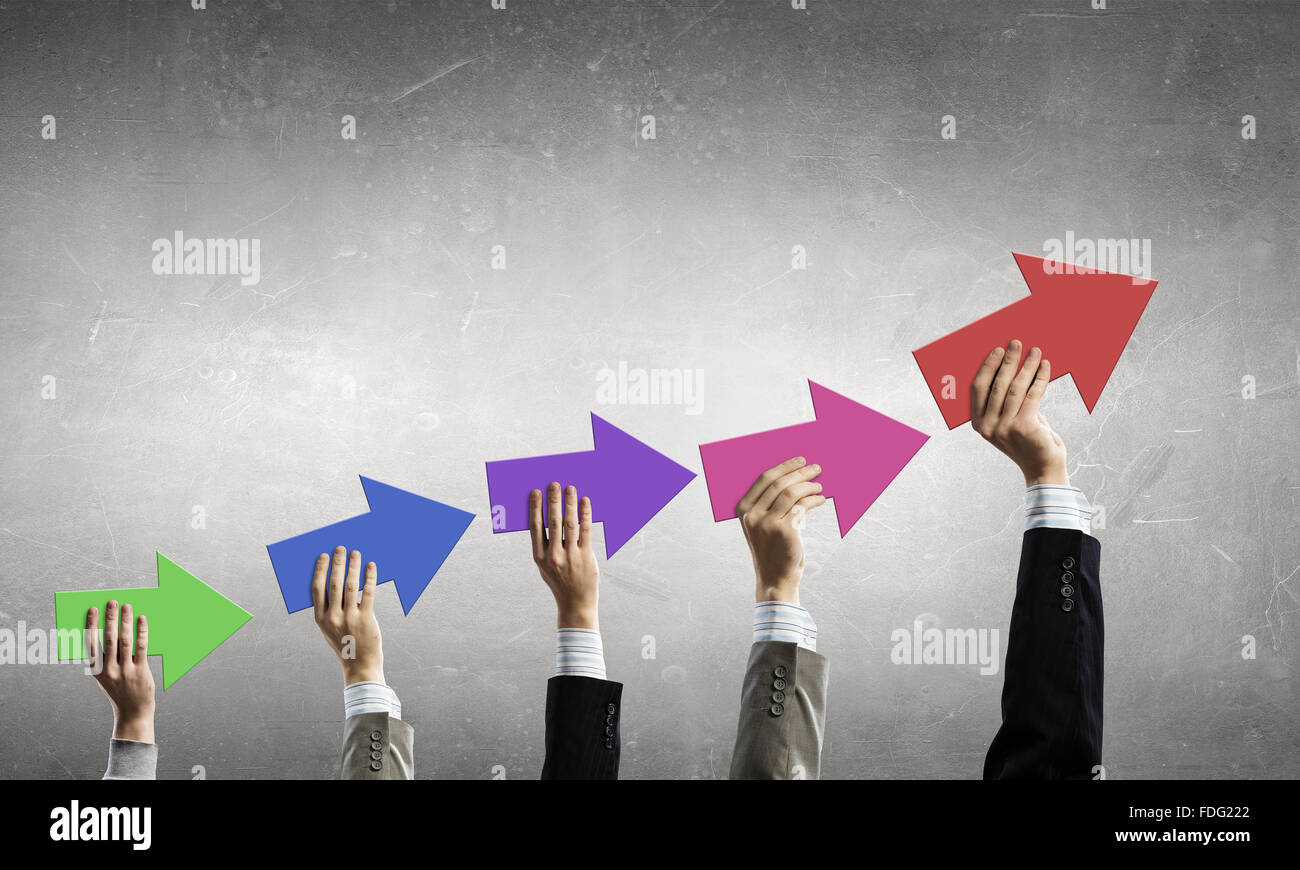 Group of business people holding growing graph in raised hands Stock ...