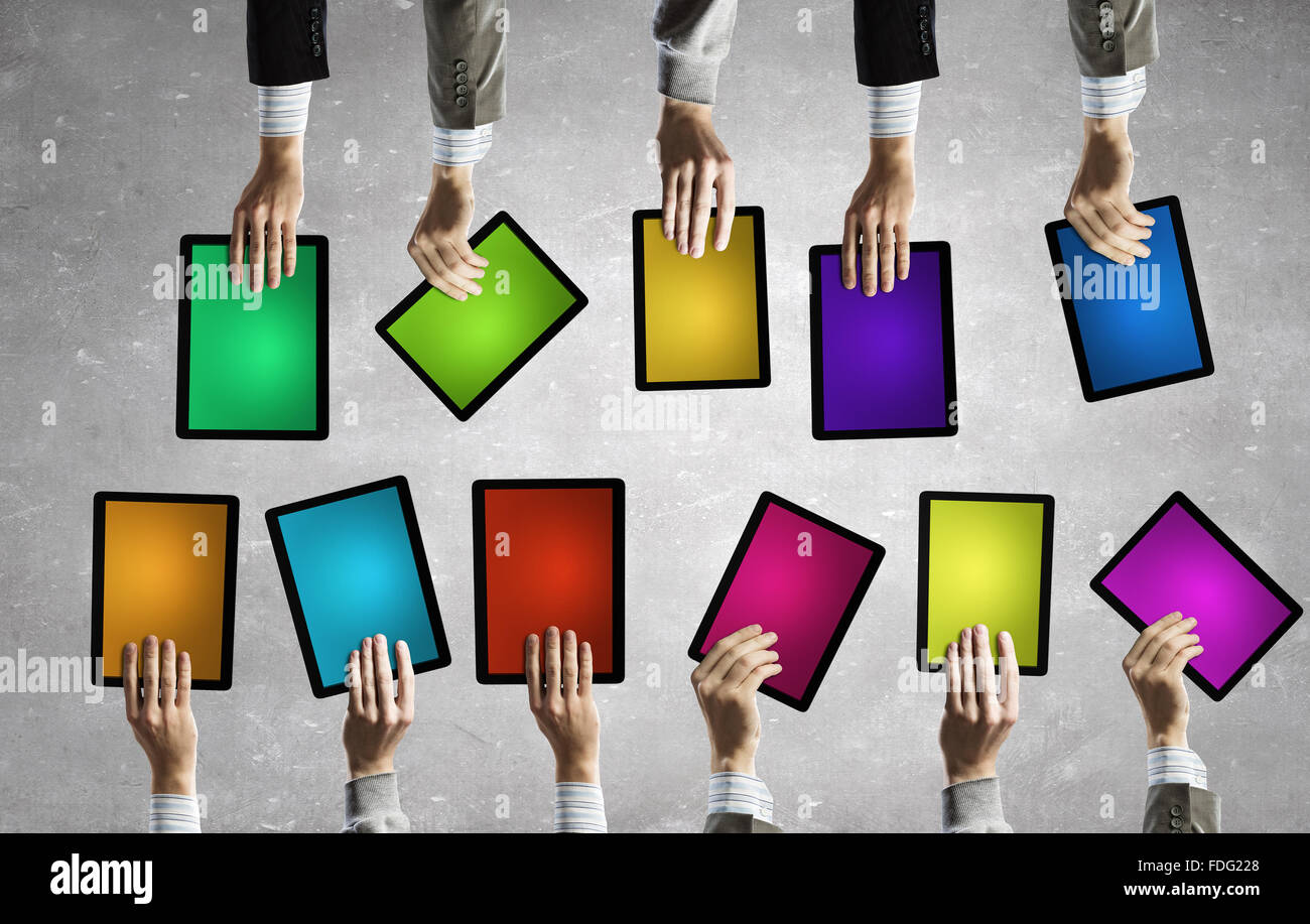 Team of business people holding tablets in hands Stock Photo - Alamy