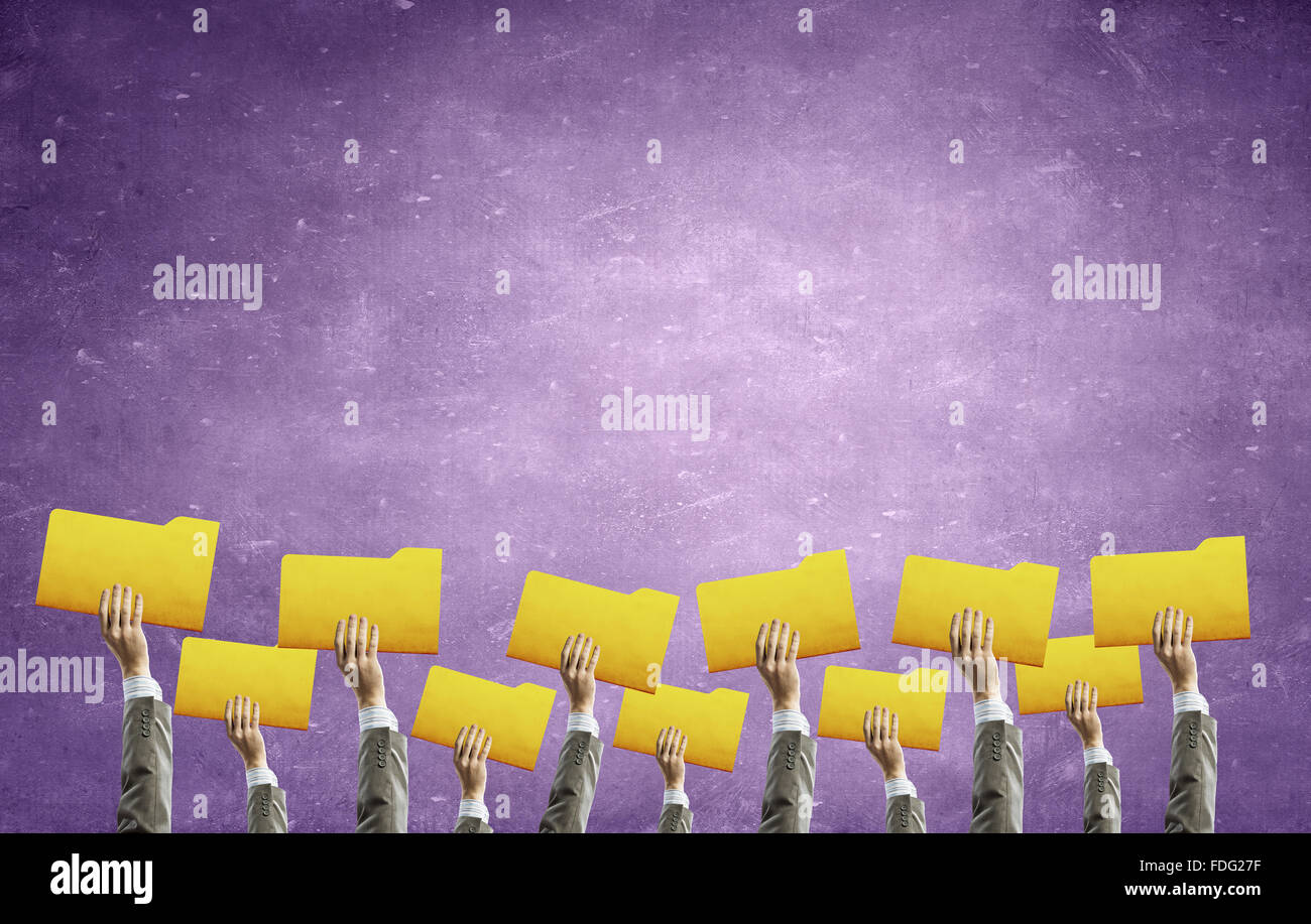 Group of business people holding folders in raised hands Stock Photo ...