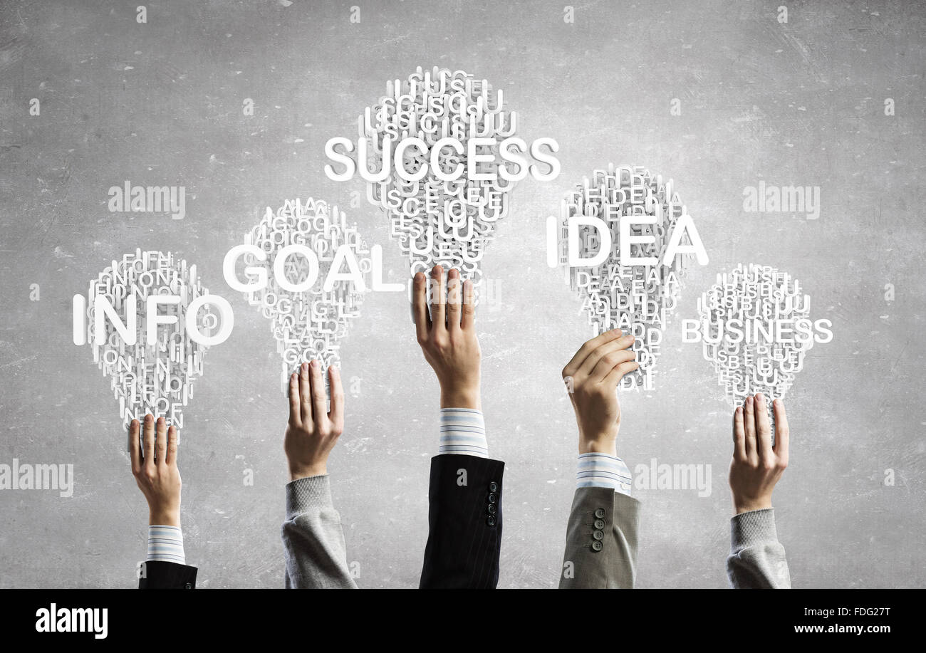 Many human hands holding light bulb signs Stock Photo - Alamy