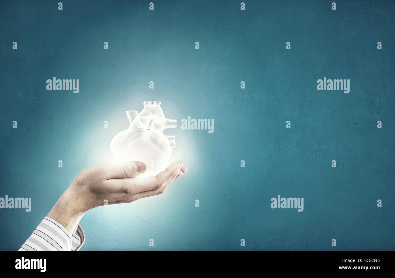 Close up of human hands holding human heart Stock Photo - Alamy