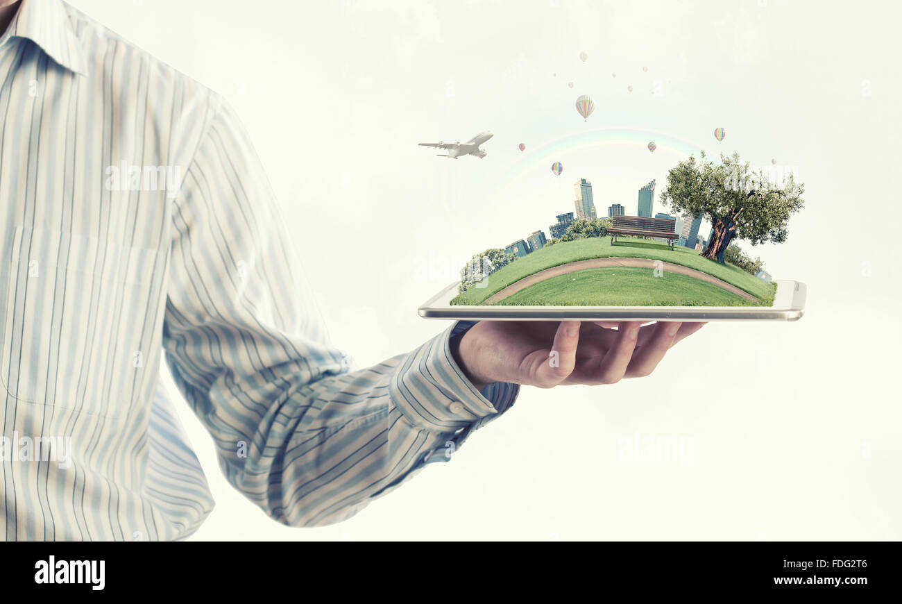 Hand holding tablet computer with cityscape on screen Stock Photo - Alamy