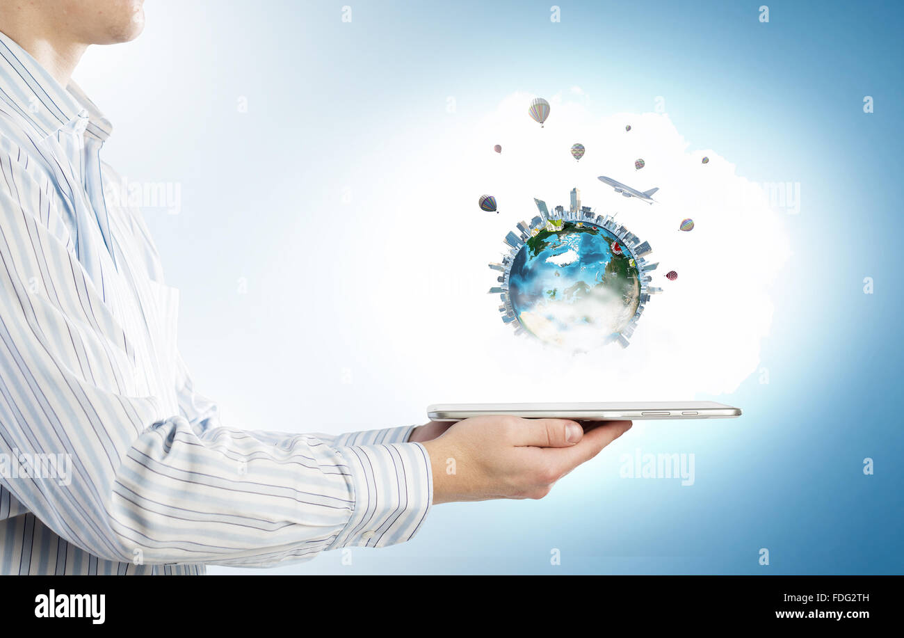 Businessman hands holding tablet pc with Earth planet on it. Elements ...