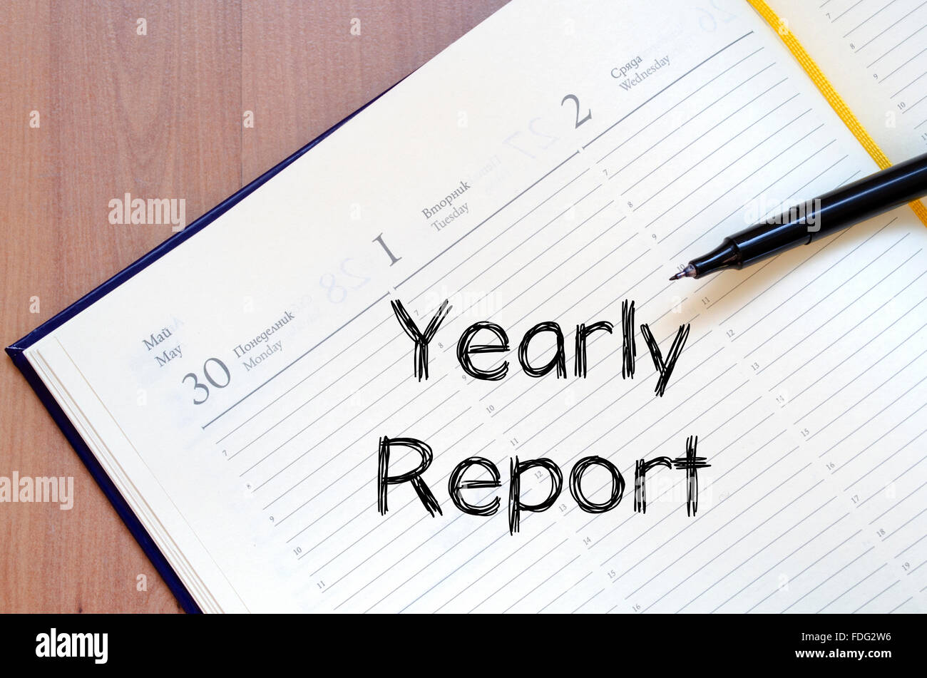 Yearly report text concept write on notebook with pen Stock Photo - Alamy