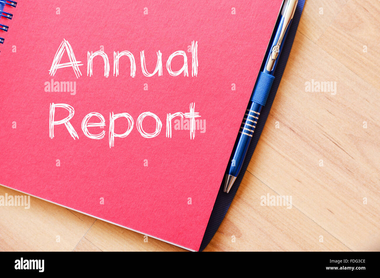 Annual report text concept write on notebook with pen Stock Photo - Alamy