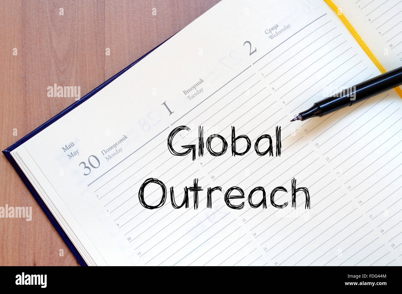 Global outreach text concept write on notebook with pen Stock Photo - Alamy