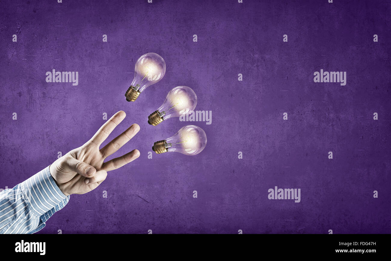 Close up of hand pointing with finger at light bulb Stock Photo - Alamy