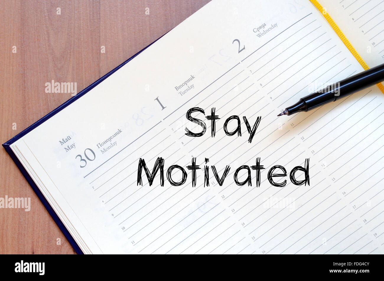 Stay motivated text concept write on notebook with pen Stock Photo - Alamy