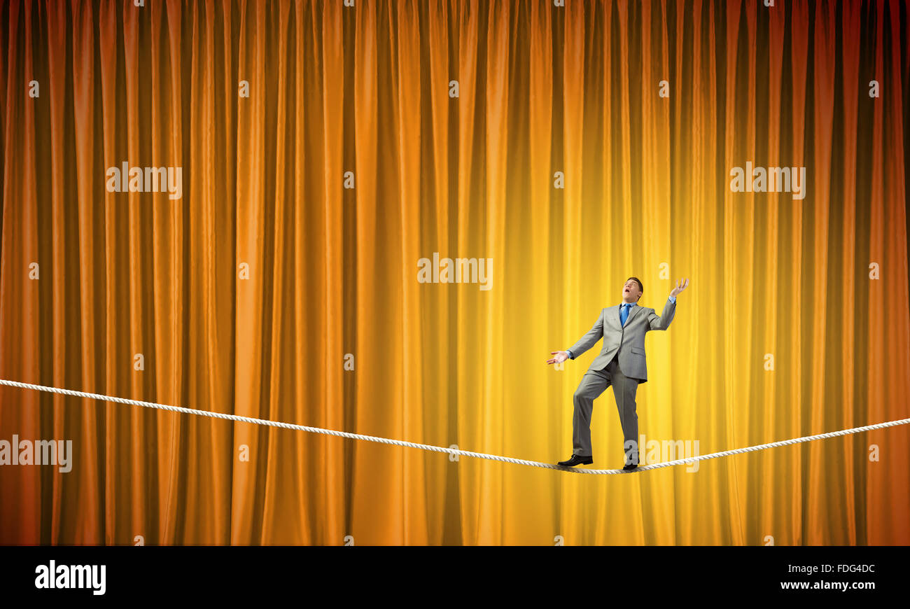 Young businessman balancing on rope and juggling with balls Stock Photo ...