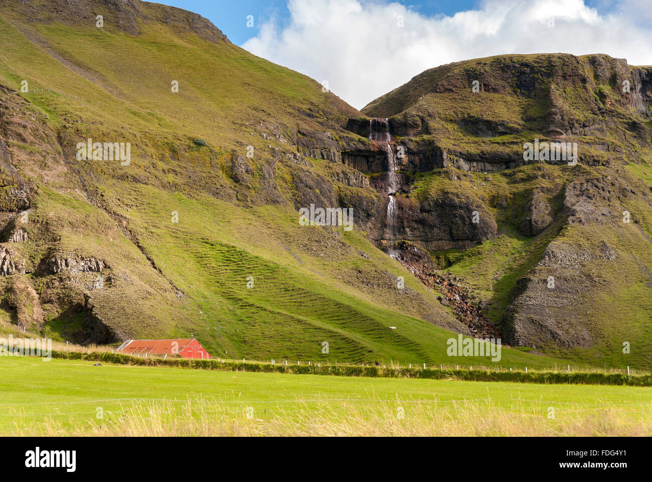 landscape with a waterfall in Vik in Iceland Stock Photo - Alamy