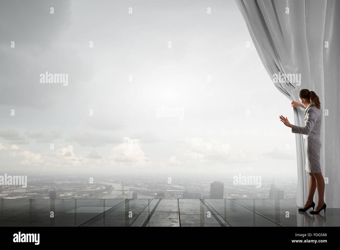 Businesswoman pulling curtain and cityscape behind it Stock Photo - Alamy