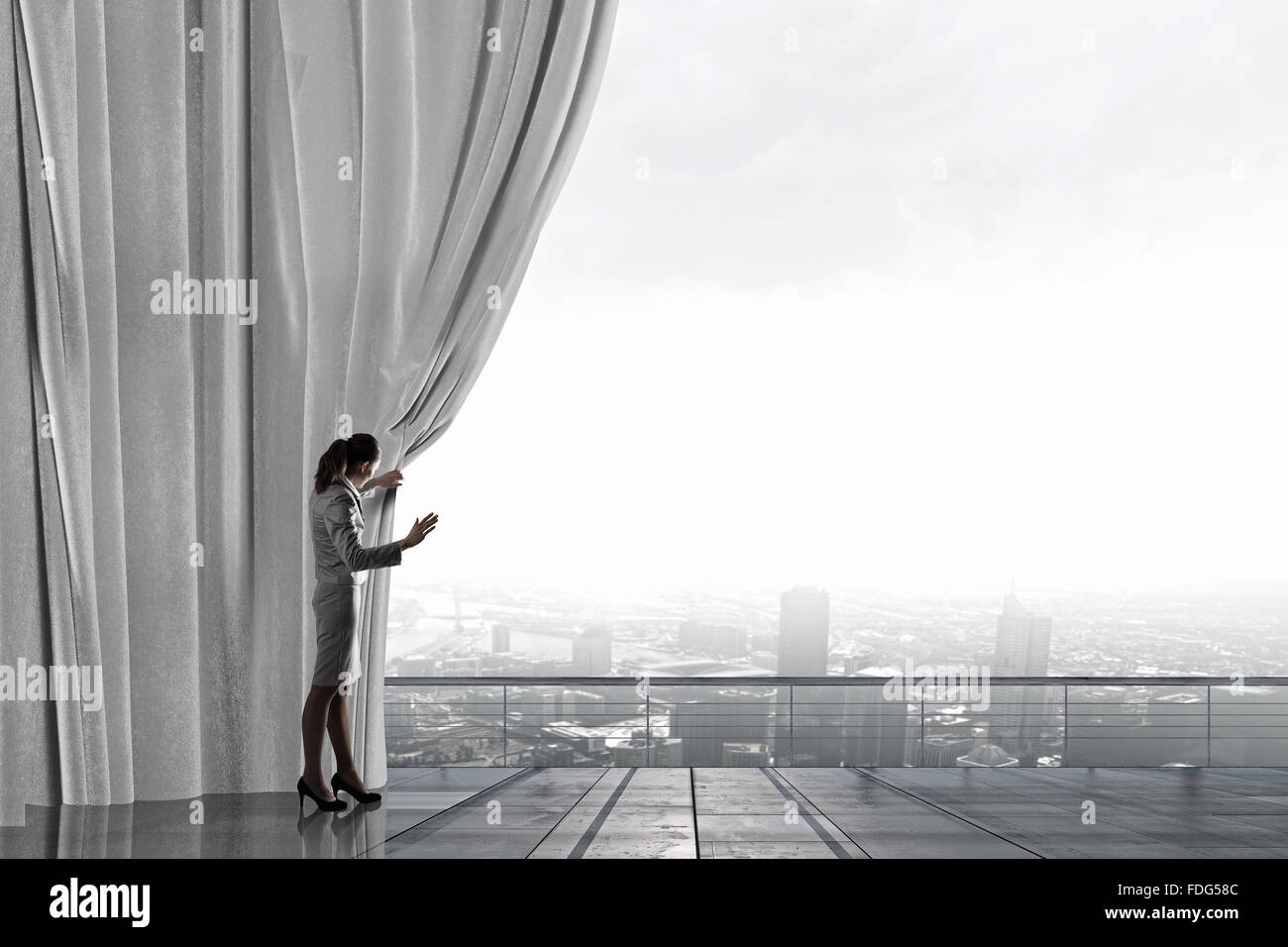 Businesswoman pulling curtain and cityscape behind it Stock Photo - Alamy