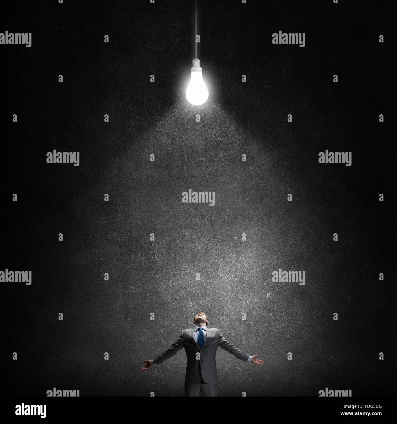 Businessman with hands spread apart and light bulb above Stock Photo ...