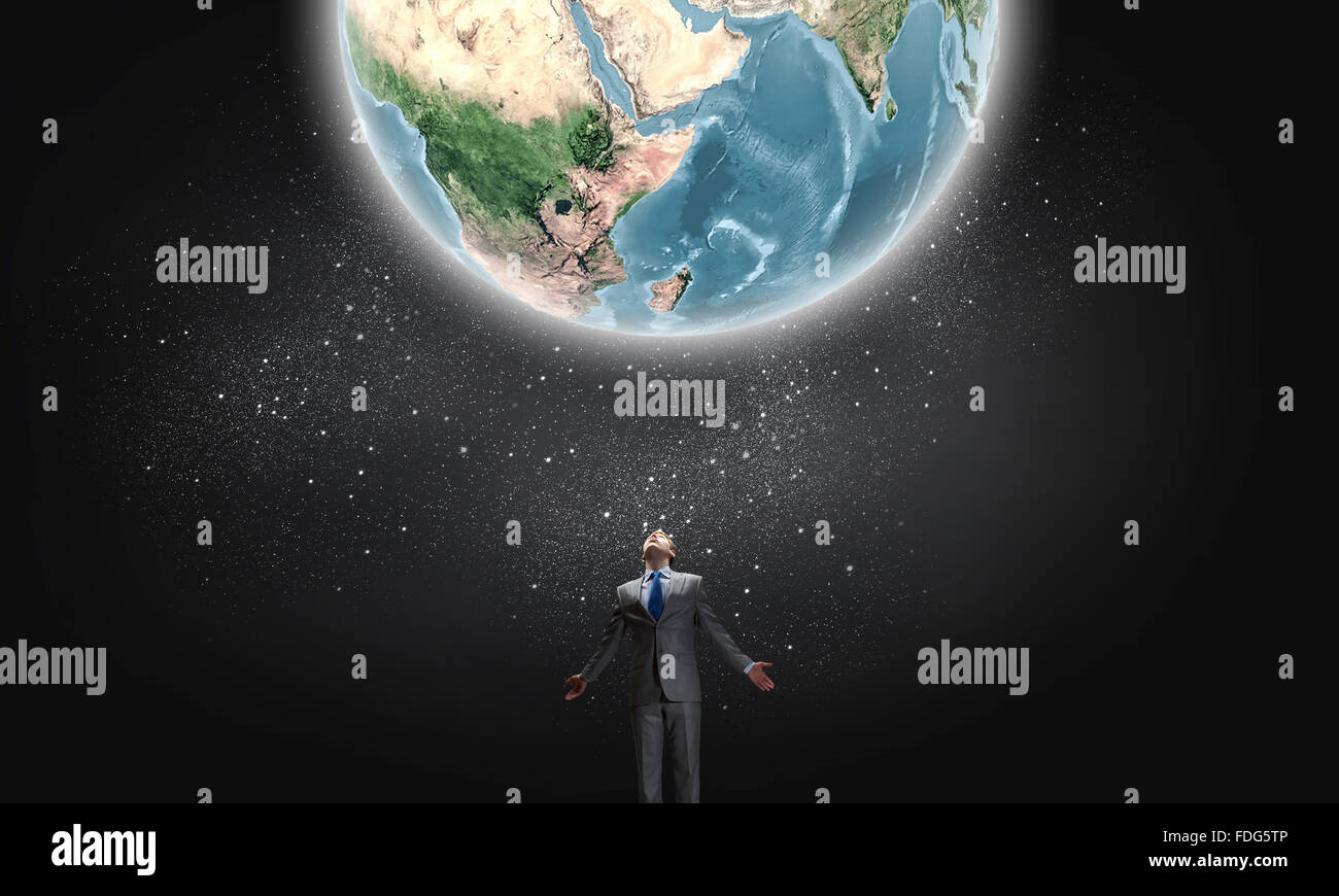 Young businessman and Earth planet above. Elements of this image are ...