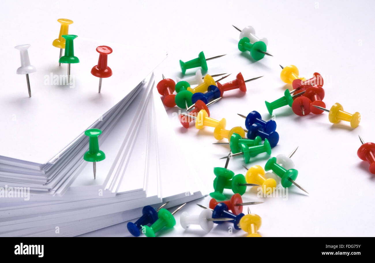 Office stationary with Colorful push pins and white note paper sheets ...