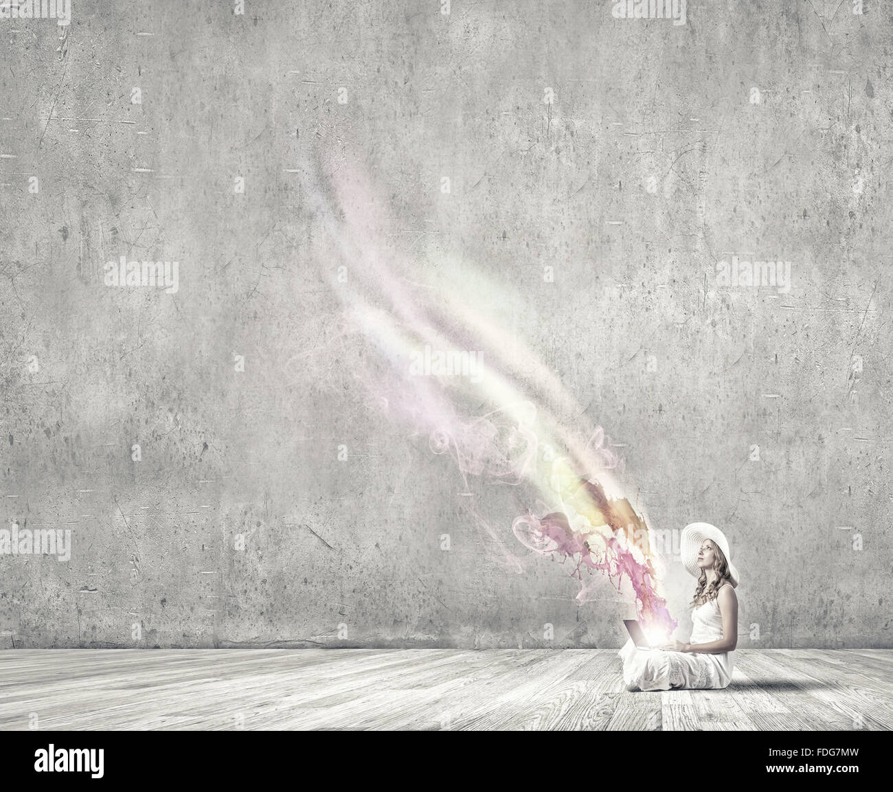 Young lady sitting on floor with laptop on knees Stock Photo - Alamy