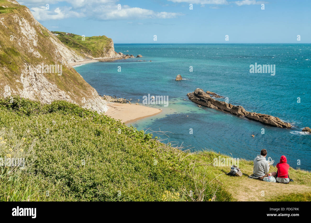 Hiker overlooking the the St Oswald Bay at the 'Durdle Door' Cliff ...