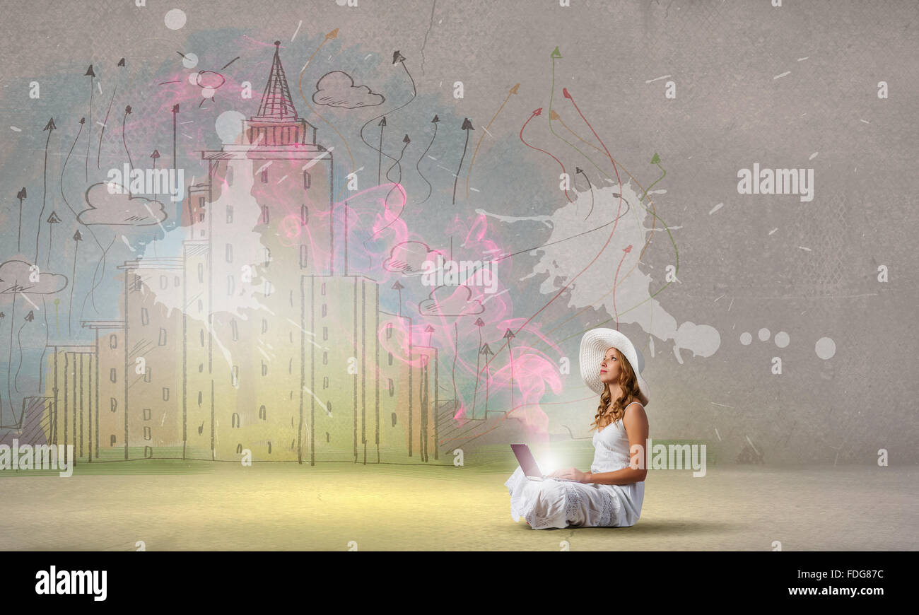 Young lady sitting on floor with laptop on knees Stock Photo - Alamy