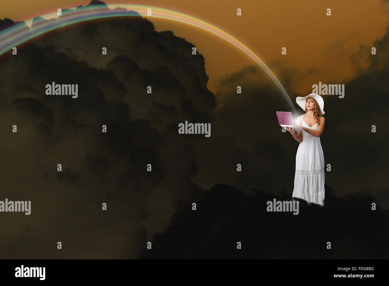 Young lady standing on cloud and using laptop Stock Photo - Alamy