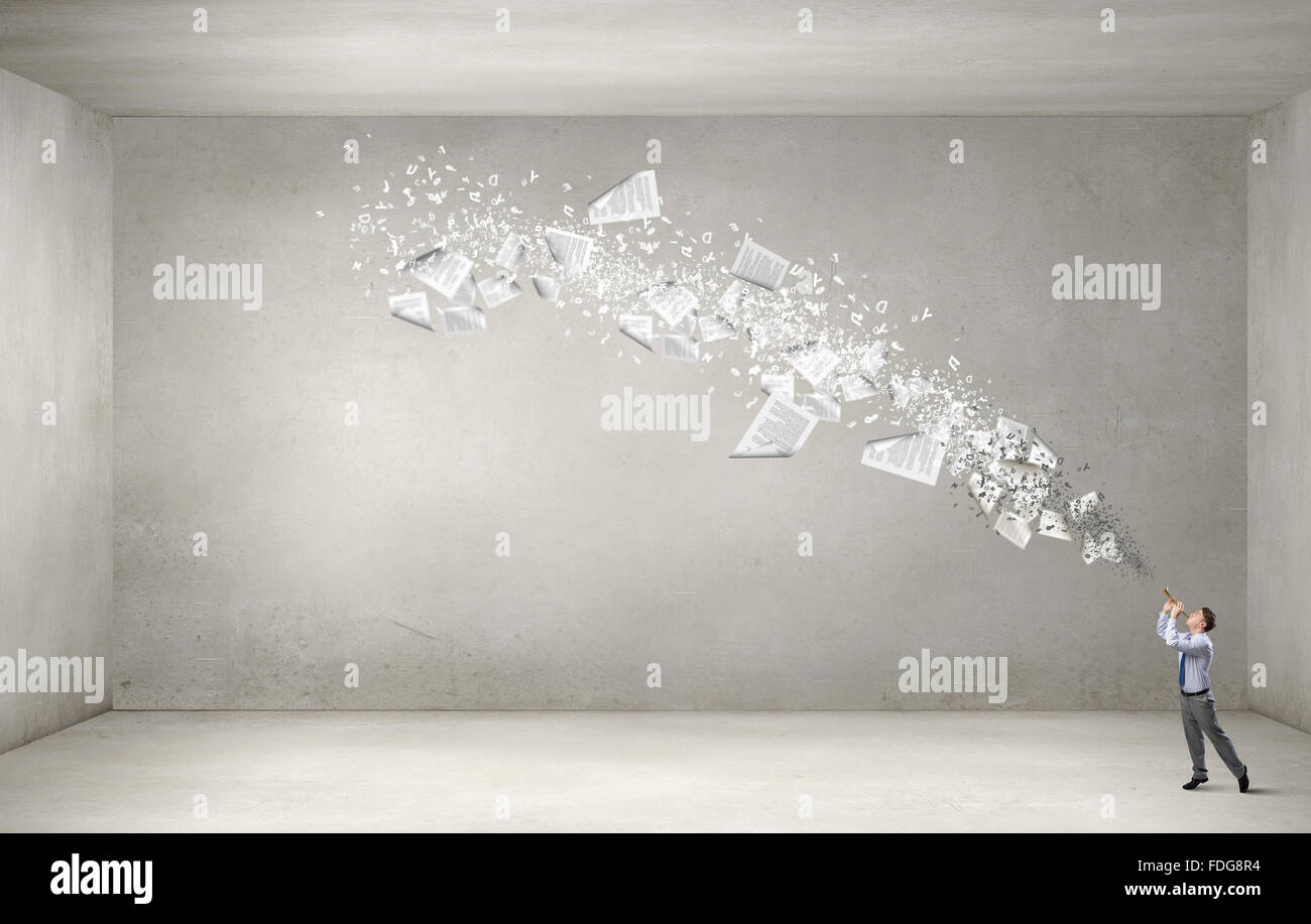 Young businessman playing flute and papers flying out Stock Photo - Alamy