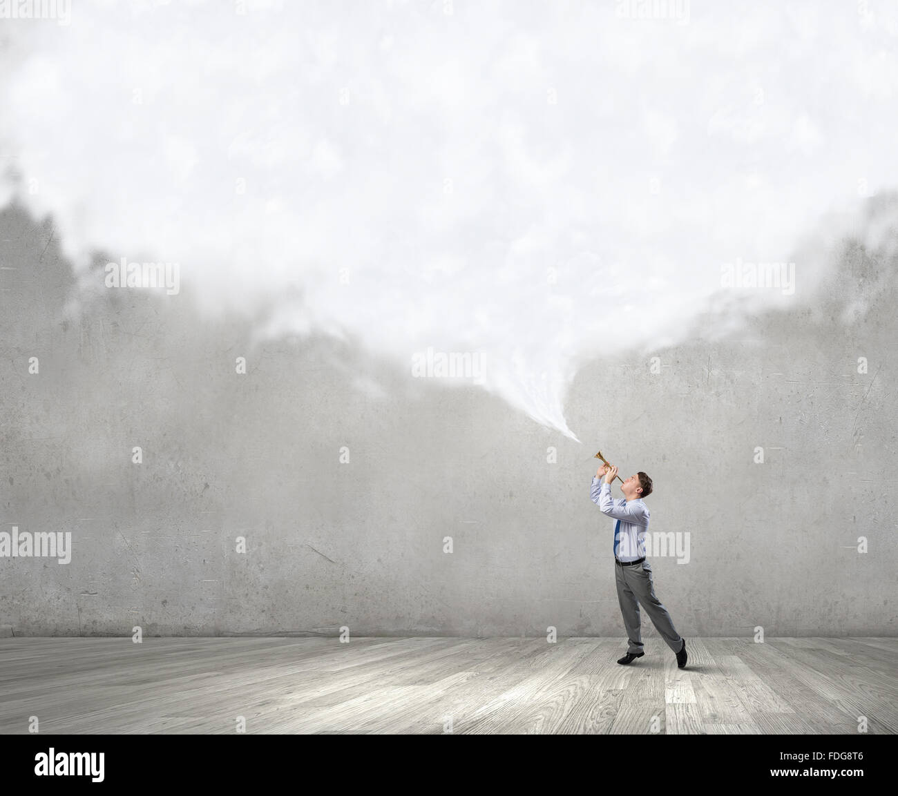 Young businessman playing pipe and cloud coming out Stock Photo - Alamy