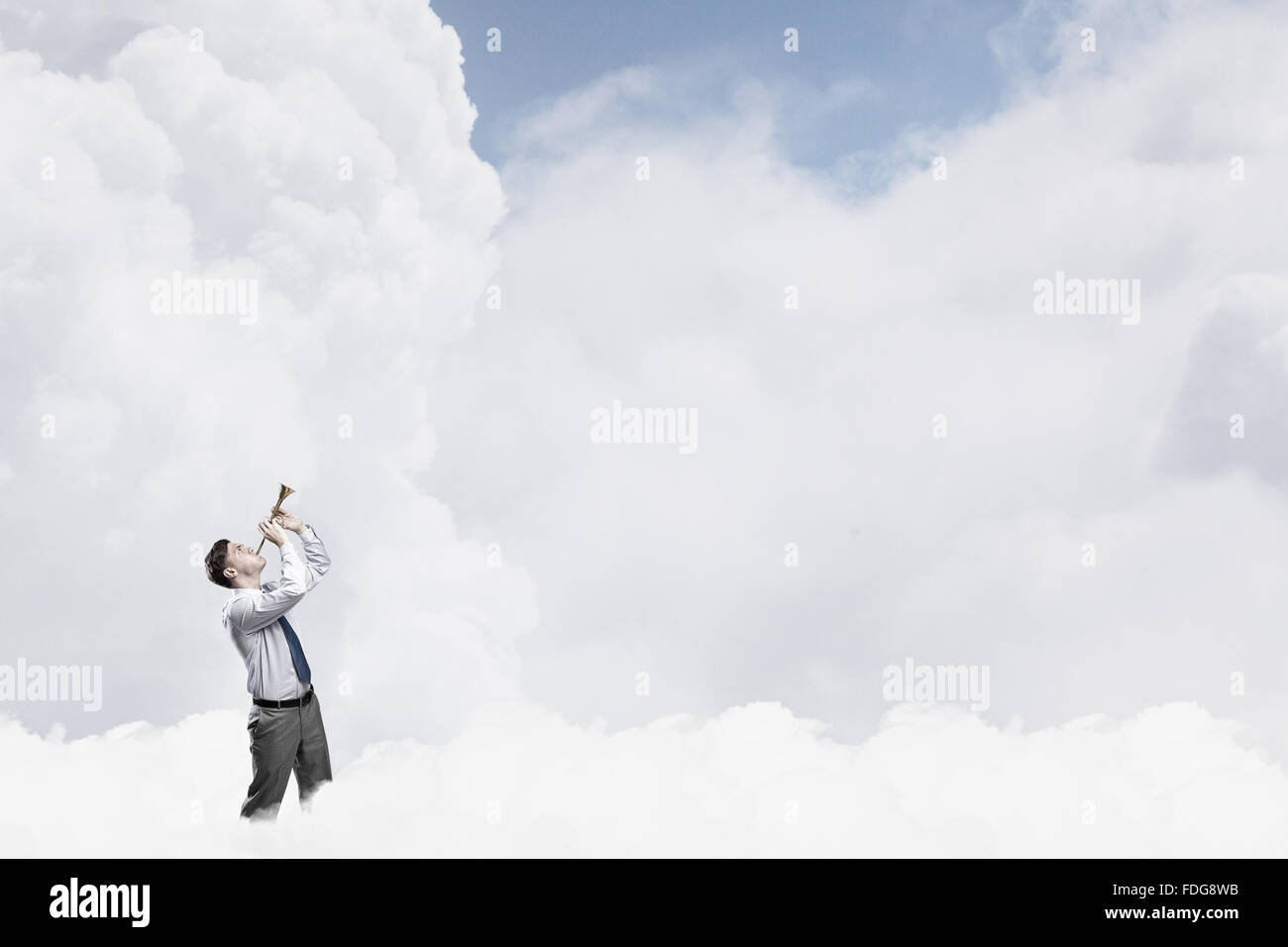 Young businessman on cloud in sky playing pipe Stock Photo - Alamy