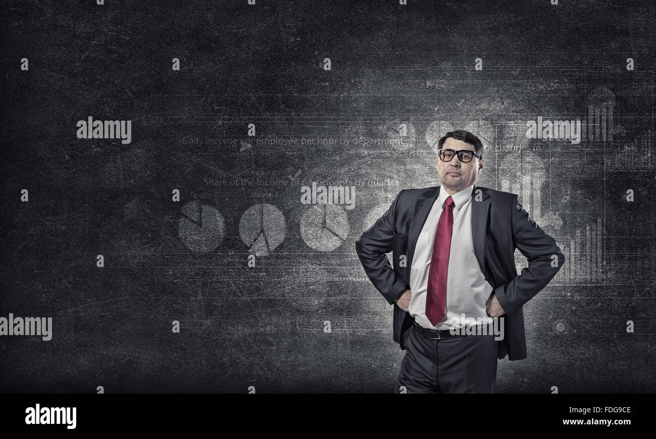 Middle aged confident businessman hands on waist Stock Photo - Alamy