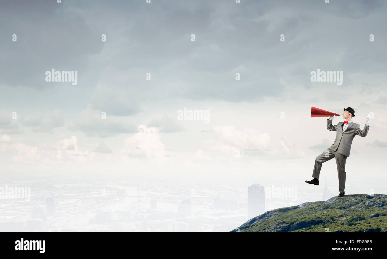 Young businessman screaming emotionally in paper trumpet Stock Photo ...