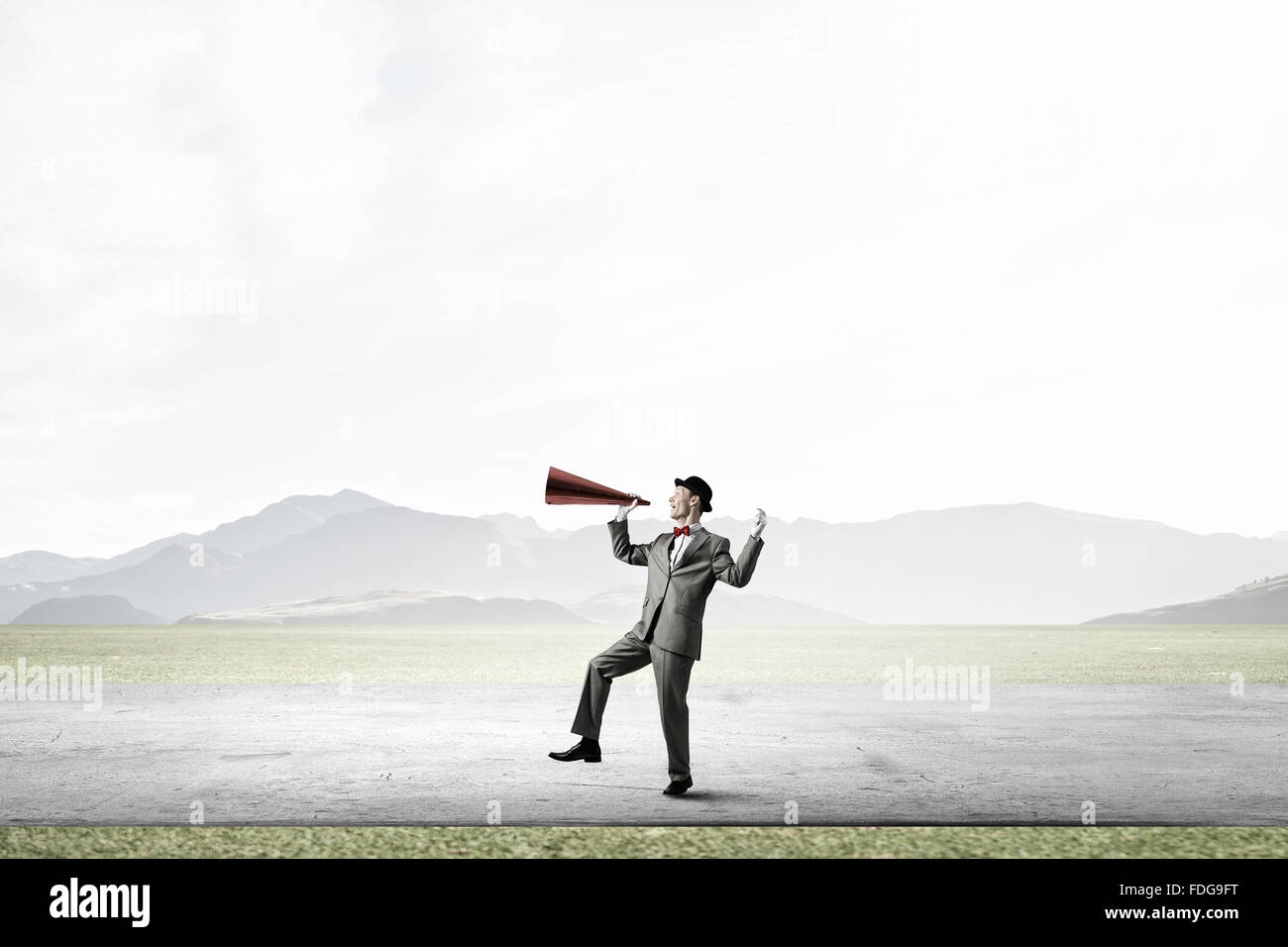 Young businessman screaming emotionally in paper trumpet Stock Photo ...