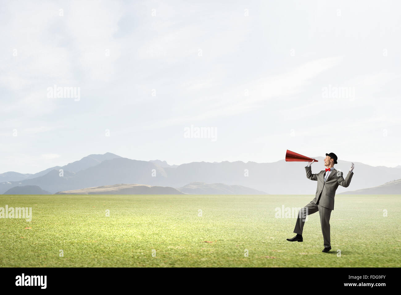 Young businessman screaming emotionally in paper trumpet Stock Photo ...