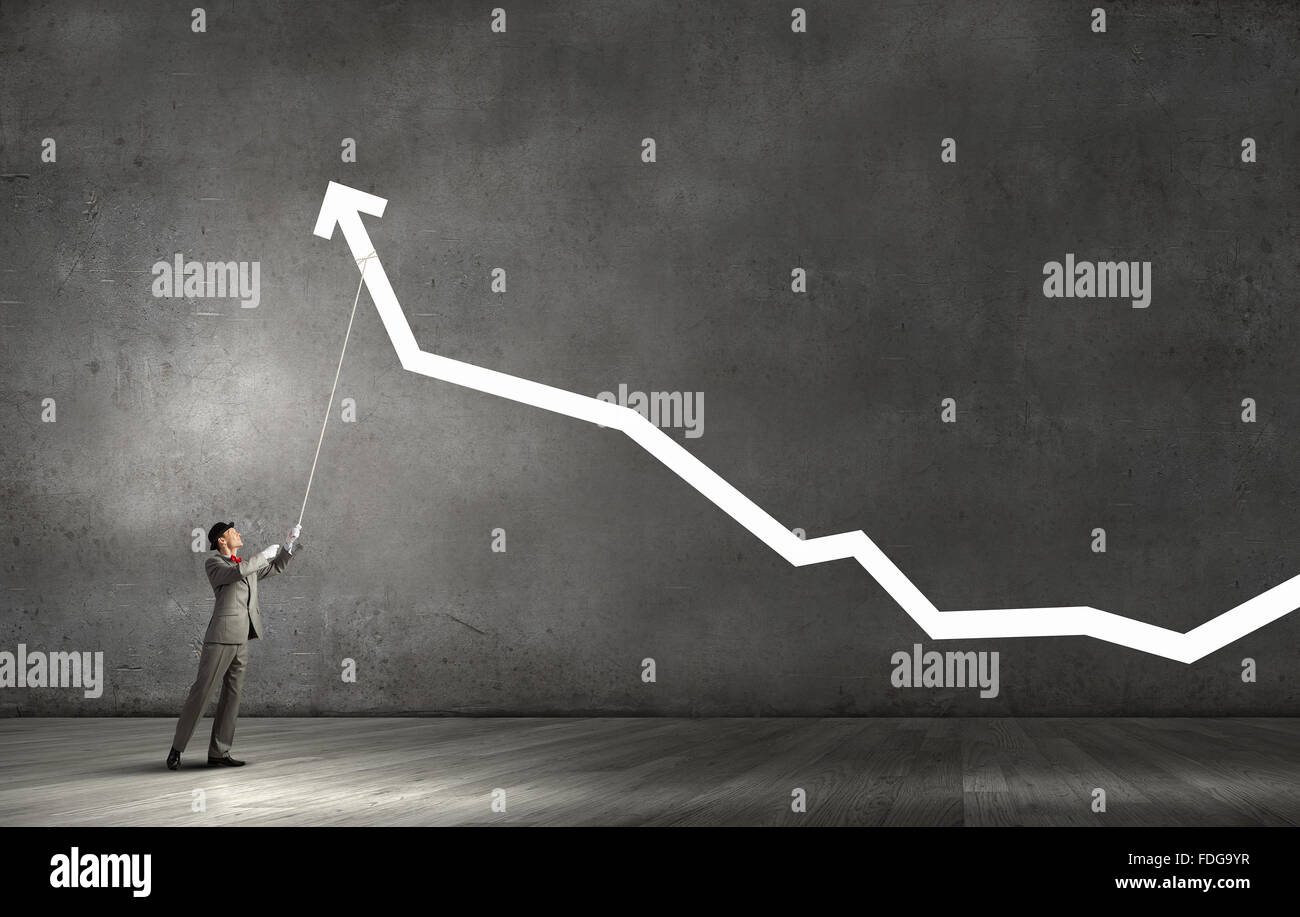Businessman pulling arrow with rope and making it raise up Stock Photo ...